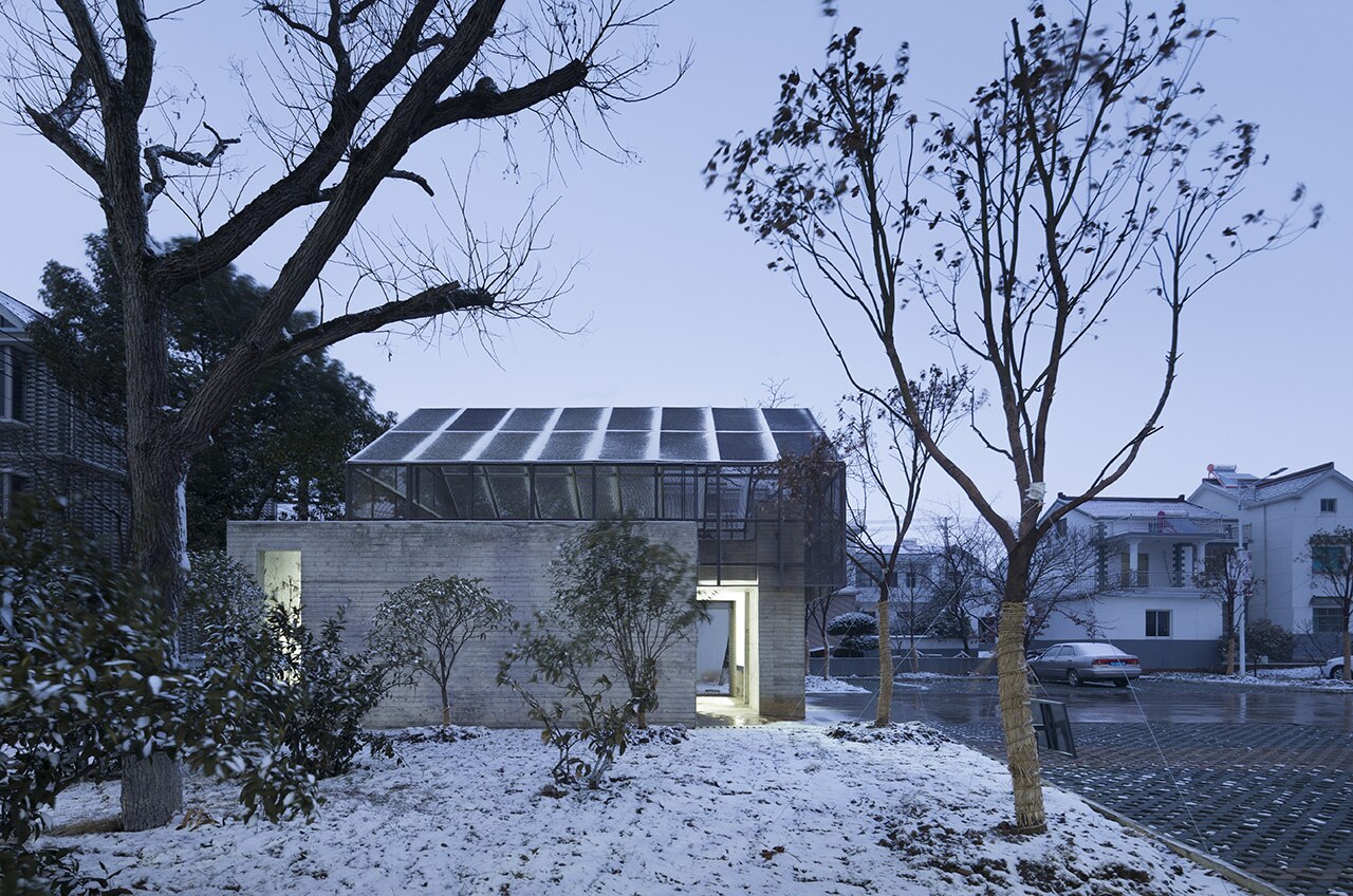 China. Glass box frames tea house within old stone walls - Domus