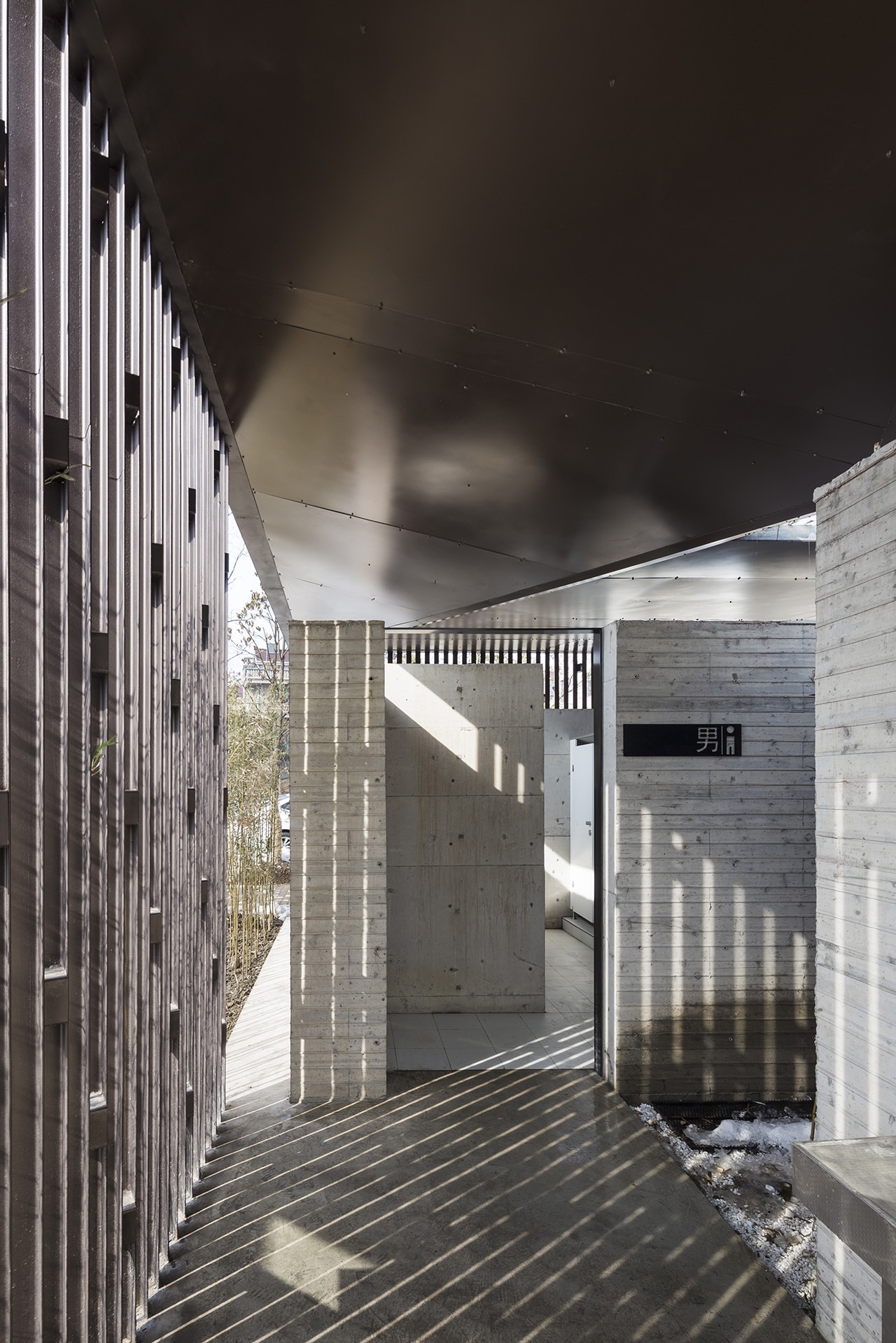 China. Glass box frames tea house within old stone walls - Domus