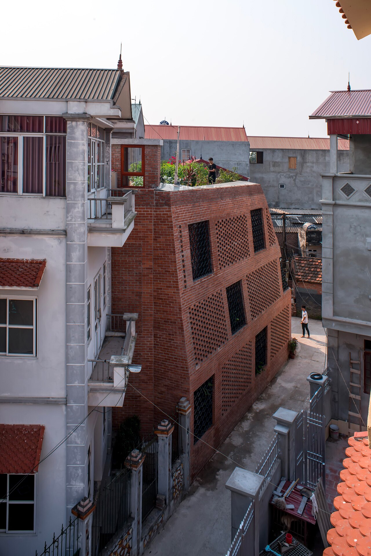 Vietnam. Designed by H&P Architects, a double brick shell encloses ...