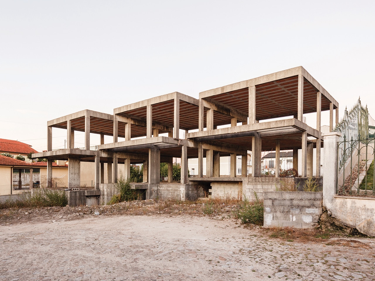 Fala Atelier completes three adjacent houses with garden in Portugal